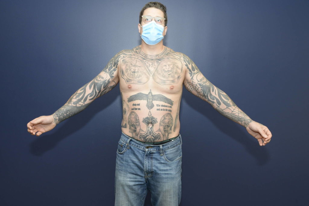 Judge releases unredacted photos of Auburn cop’s tattoos | Kent Reporter